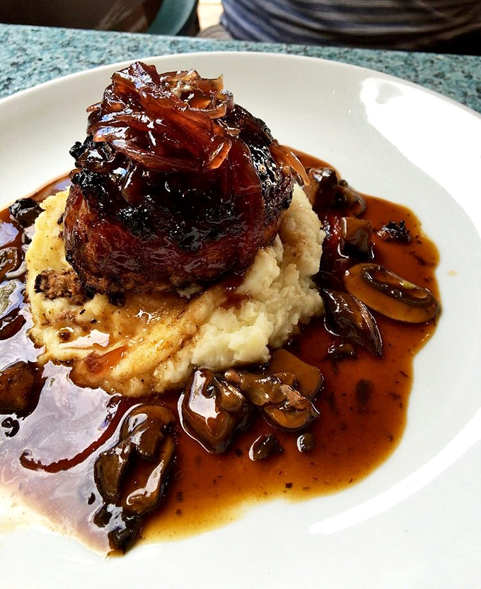 A filet mignon atop creamy mashed potatoes with mushroom sauce&mdash;proof that heaven exists and it's made of beef.