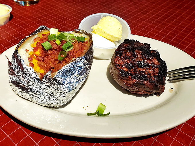 A filet that would make cowboys weep with joy, paired with a loaded baked potato wrapped in foil like a delicious silver present.