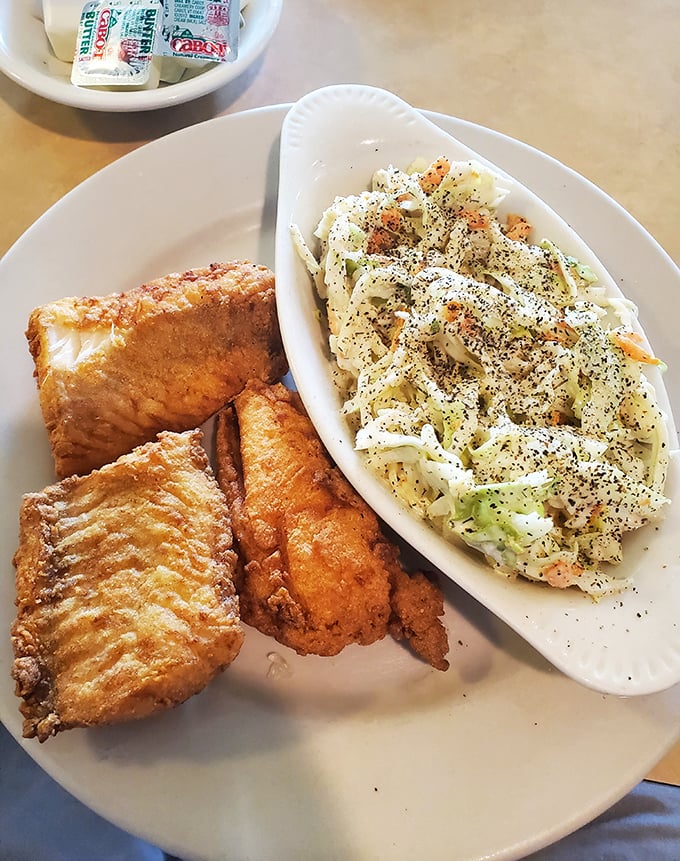 Golden-battered haddock that shatters at first bite, paired with creamy coleslaw. The ocean and garden, united on a single plate.