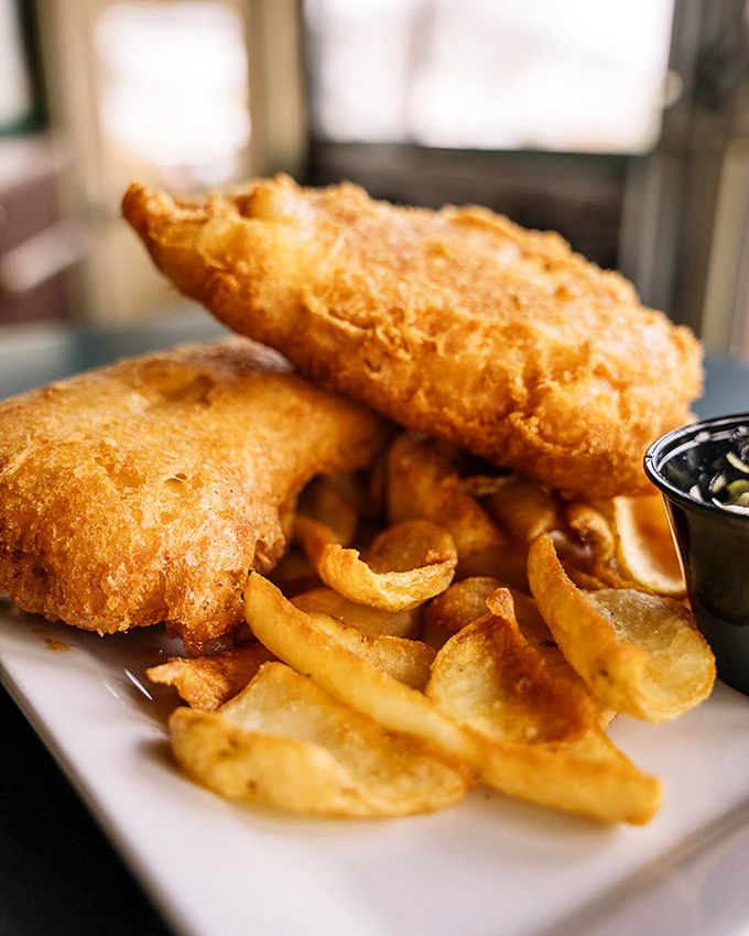 The Fish and Chips arrive like crispy golden pillows from heaven&mdash;flaky cod encased in beer batter with chips that strike the perfect balance between crisp and tender.