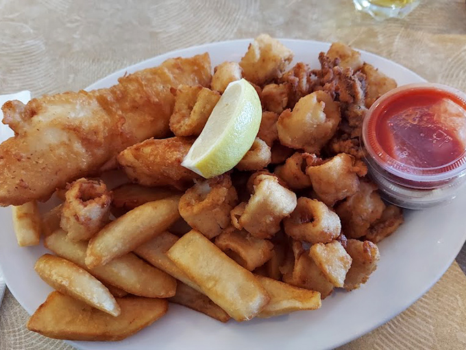 Golden-battered fish and chips that crackle with each bite, served with a wedge of lemon that's not just garnish but a necessary flavor companion.
