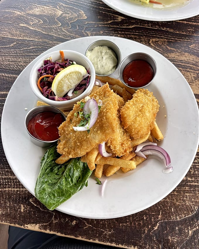 Fish and chips that would make a British pub jealous – crispy exterior giving way to flaky white fish, with slaw that actually deserves to be eaten, not pushed aside.