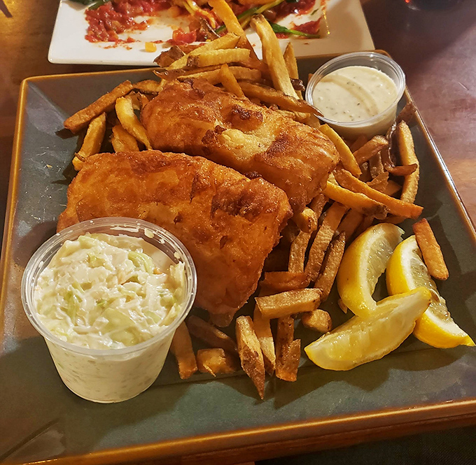 Golden-battered cod that shatters at first bite, paired with chips that could make a potato proud. This is fish and chips done right.