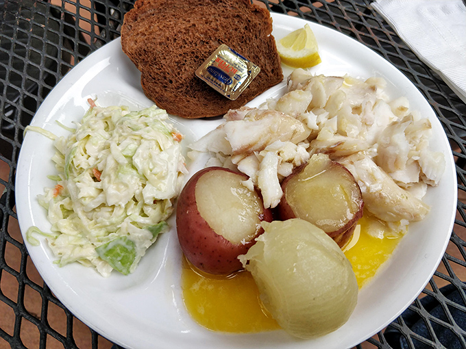 The fish dinner arrives like an edible postcard from Wisconsin's lakes—flaky white fish, red potatoes, and coleslaw creating the perfect Midwestern trinity.