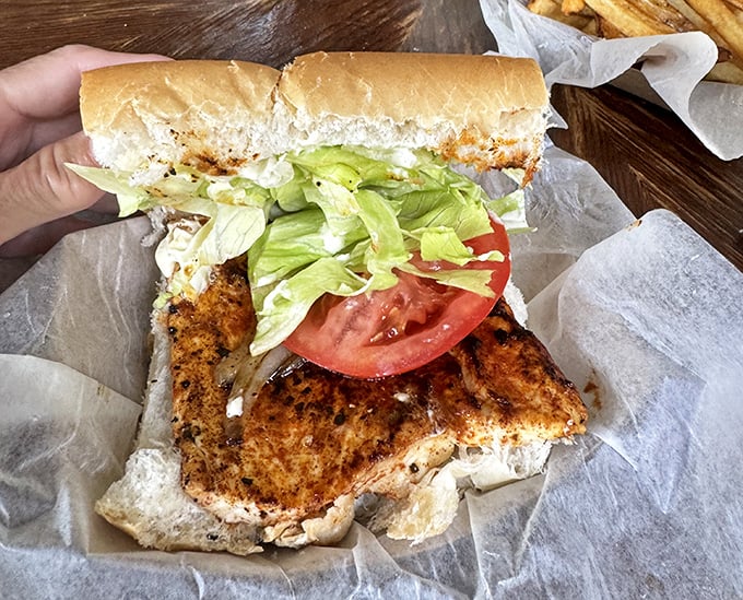 This isn't just a sandwich; it's Florida's edible postcard. Crispy grouper, fresh veggies, and Cuban bread create seafood perfection.