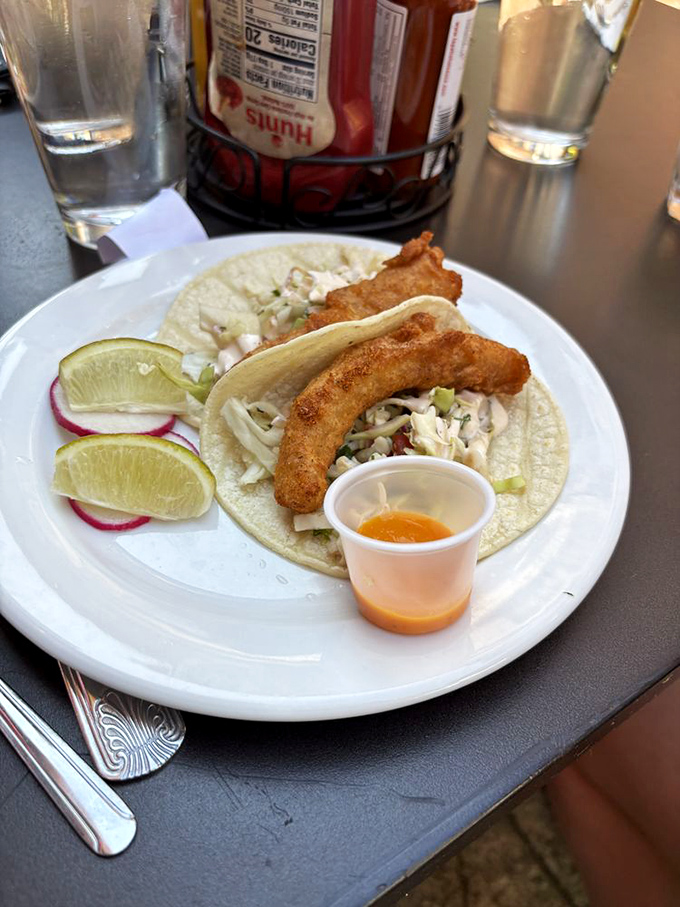 Fish tacos done right, where crispy meets creamy in a tortilla-wrapped symphony of coastal flavors.