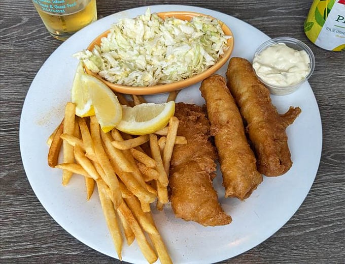Fish and chips that would make a British pub jealous. The golden batter crackles with each bite, while the coleslaw adds that perfect tangy counterpoint.