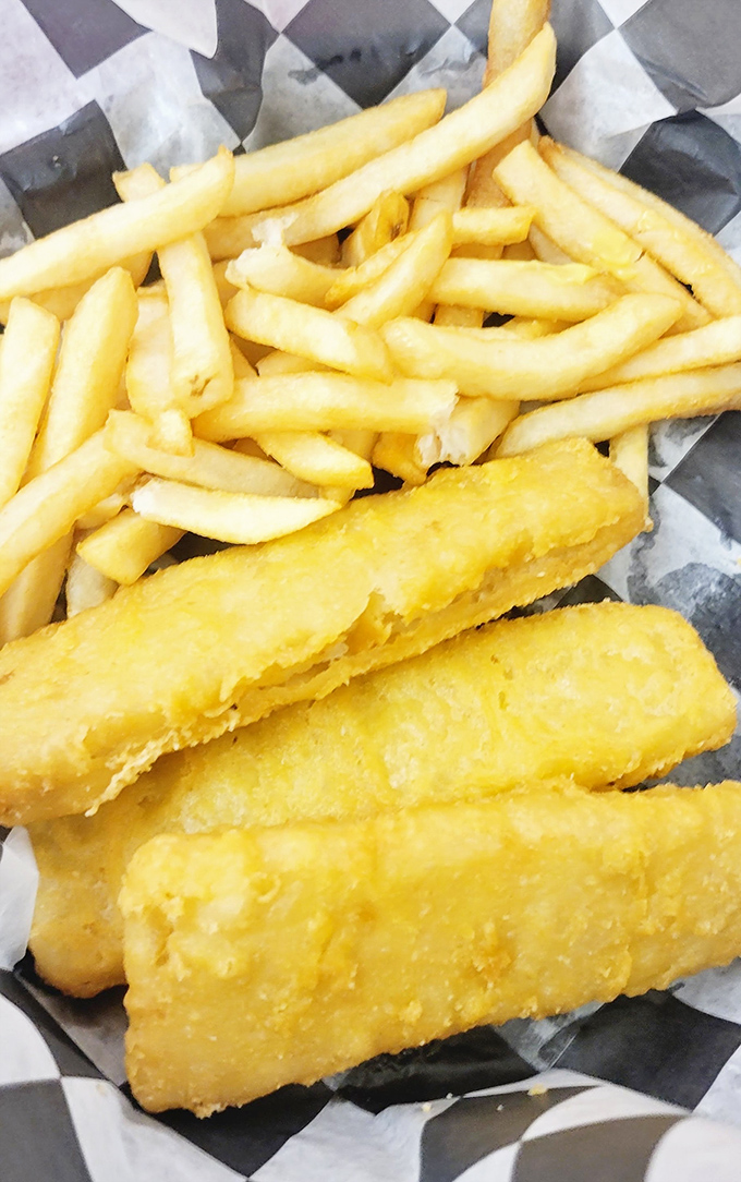 The star of the show: golden-battered fish that shatters with each bite, alongside fries that understand the perfect balance between crisp and fluffy.