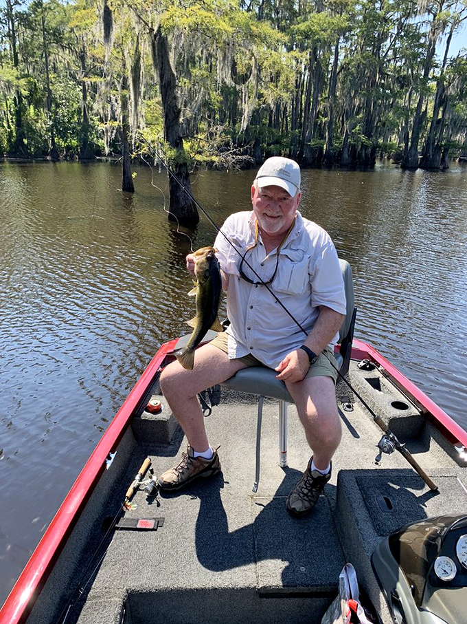 The universal language of fishing: man, boat, water, and the triumphant smile that says, "Dinner plans have changed!"