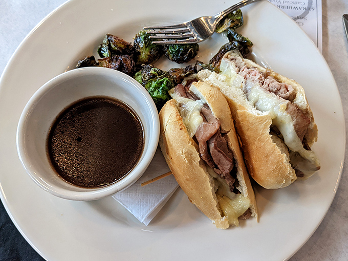 The French dip arrives looking like it just graduated from sandwich finishing school with honors and au jus.
