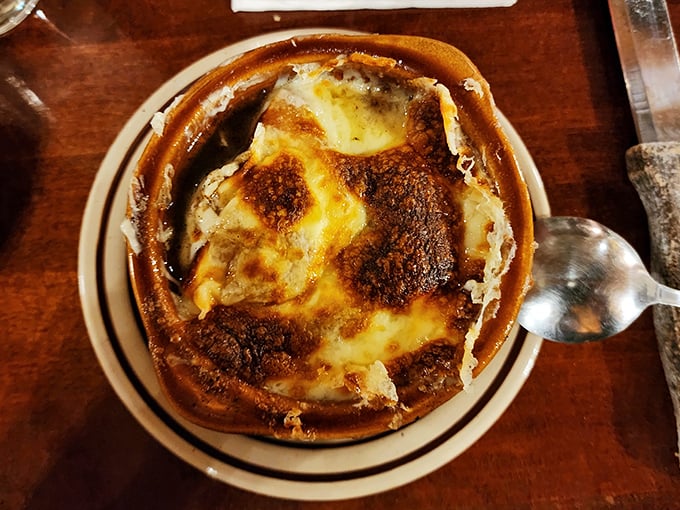 French onion soup wearing its cheese blanket like a cozy winter sweater, bubbling with promise.