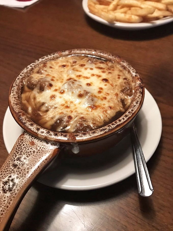 This isn't just French onion soup; it's a cheese-crowned masterpiece that would make Julia Child nod in approval while reaching for a spoon.