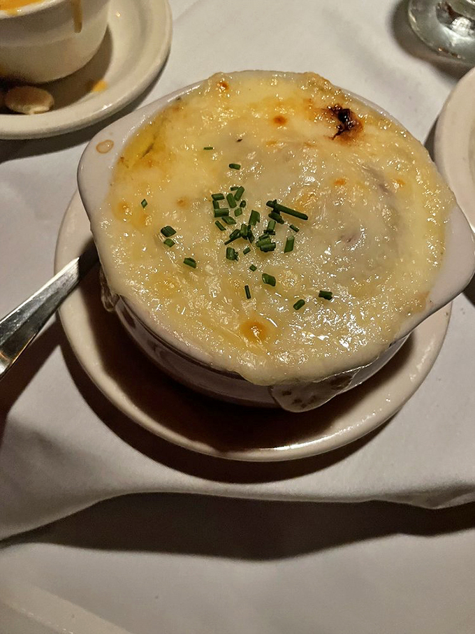 This French onion soup isn't just comfort food&mdash;it's a bubbling cauldron of cheese-capped bliss worth every chin dribble.