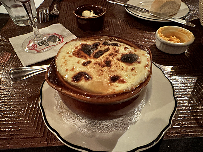 This isn't just French onion soup; it's a cheese-crowned masterpiece with a bubbling, bronzed top that demands to be cracked like cr&egrave;me br&ucirc;l&eacute;e.