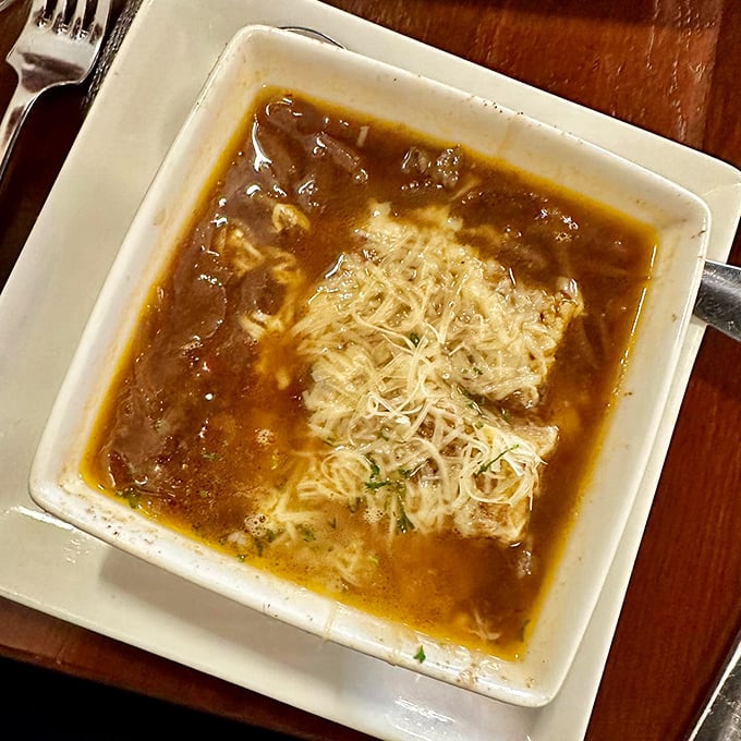 This isn't just French onion soup; it's a soul-warming bowl of tradition with a crown of melted cheese that stretches with each spoonful.