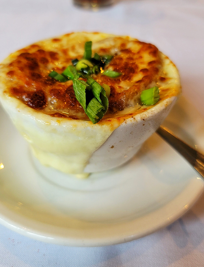 This isn't just French onion soup; it's a bubbling cauldron of cheese-capped comfort that your grandmother wishes she could make.