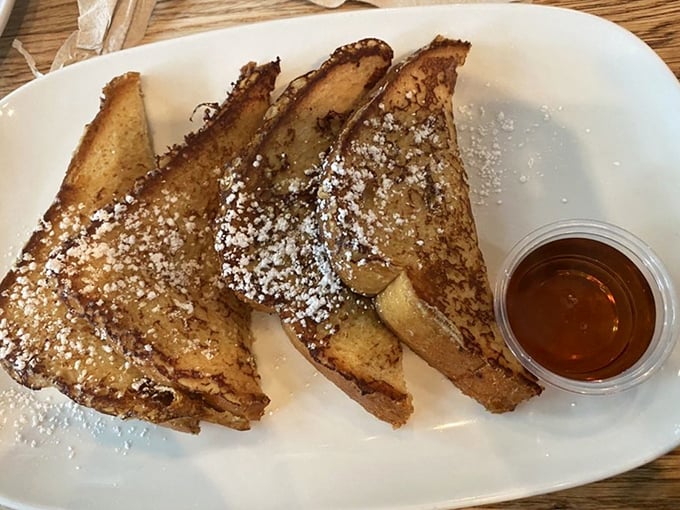French toast that doesn't just participate in breakfast&mdash;it throws a parade. Dusted with powdered sugar and served with amber syrup for dunking perfection.