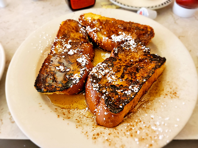 French toast that arrives looking like it graduated summa cum laude from breakfast university with honors in deliciousness.
