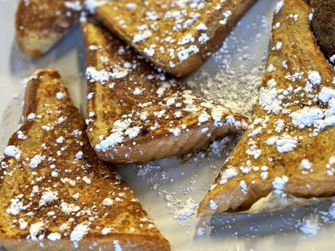 French toast dusted with powdered sugar like the first snow of winter &ndash; simple perfection that doesn't need Instagram filters to impress.