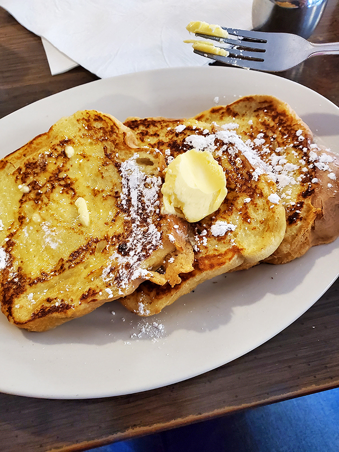 French toast that's achieved the perfect golden-brown exterior while maintaining that custardy interior. The powdered sugar isn't decoration&mdash;it's a well-deserved crown.