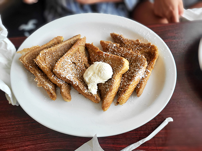 French toast triangles dusted with powdered sugar and topped with a dollop of butter&mdash;simple perfection that needs no passport to impress.