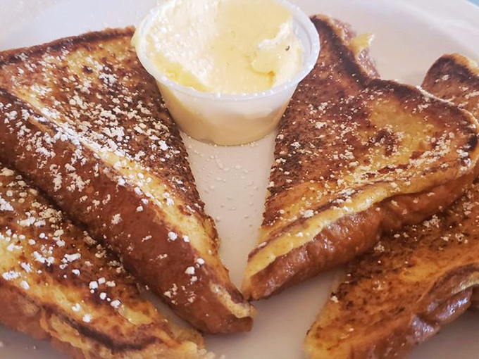 French toast that's achieved that mythical balance &ndash; crispy exterior, custardy interior, and enough powdered sugar to make your dentist wince with delight.