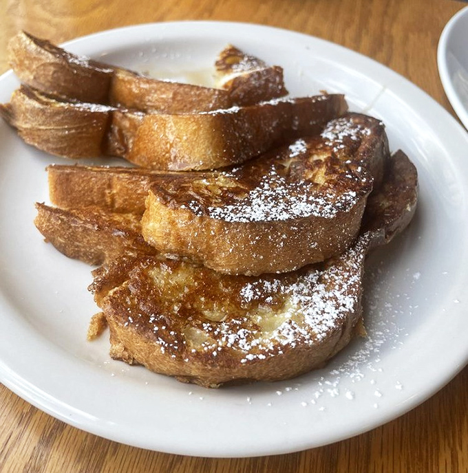 French toast that makes you question every other breakfast decision you've ever made. That dusting of powdered sugar? Chef's kiss.