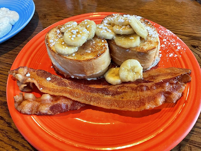 French toast elevated to art form&mdash;golden slices topped with caramelized bananas and a dusting of powdered sugar that would make even dessert jealous.