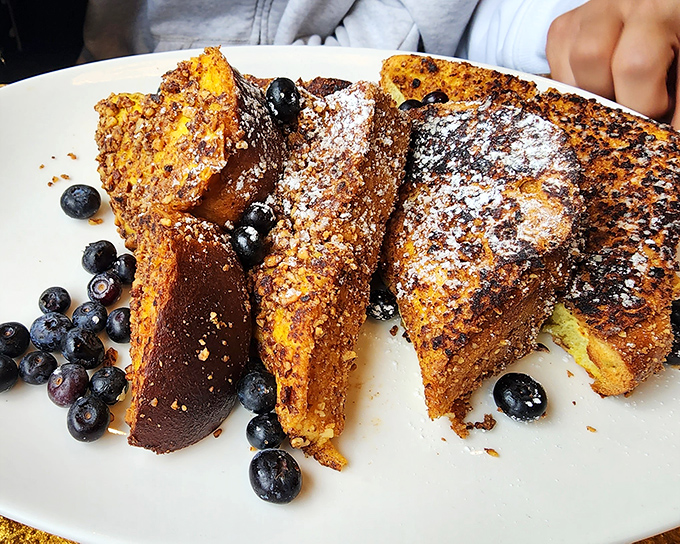 French toast that deserves its own Instagram account&mdash;golden-brown, dusted with powdered sugar, and surrounded by fresh blueberries like edible jewels.