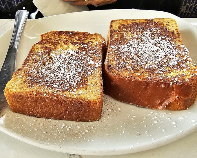 French toast so thick and golden, it makes regular bread look like it needs therapy. Powdered sugar snowfall included.