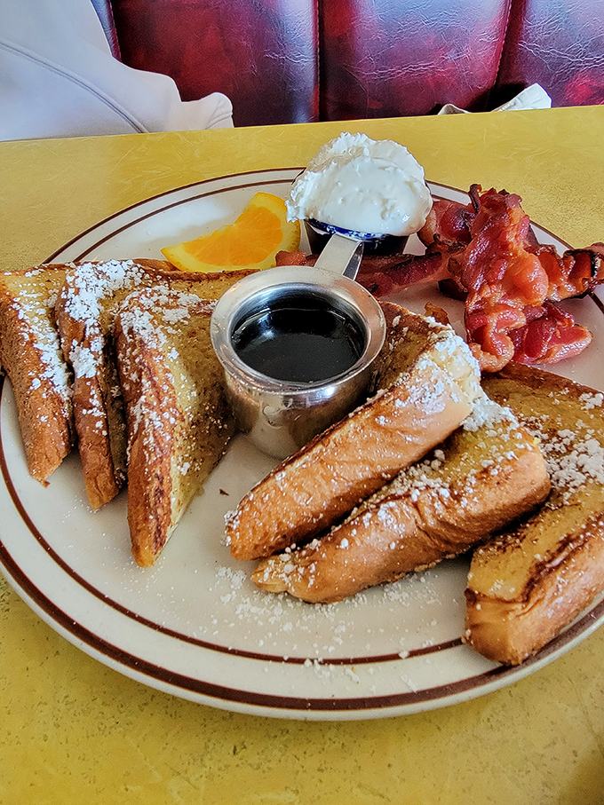French toast triangles that could make a pancake jealous, served with a side of perfectly crispy bacon.