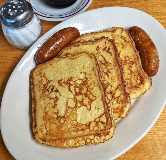 Golden-brown French toast that achieves the impossible: crispy edges, custard-soft center, and enough sustenance to power through hours of beach volleyball.