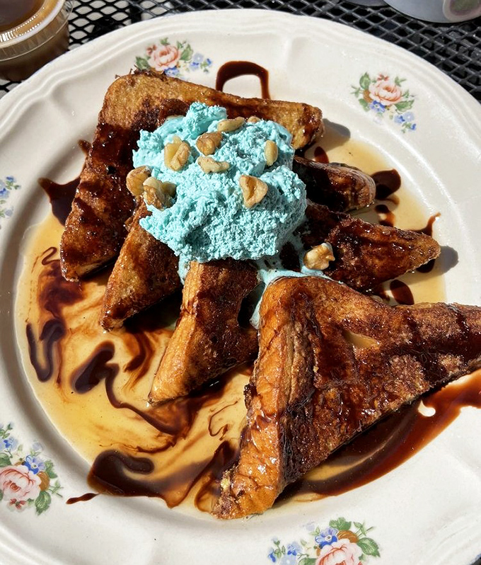 Blue whipped cream might raise eyebrows elsewhere, but atop this French toast masterpiece, it's the crown jewel of a breakfast that refuses to be boring.