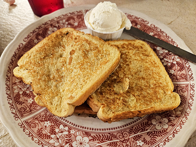 Golden-brown French toast that's achieved that perfect crisp-yet-custardy balance, with a scoop of butter melting into every nook and cranny.