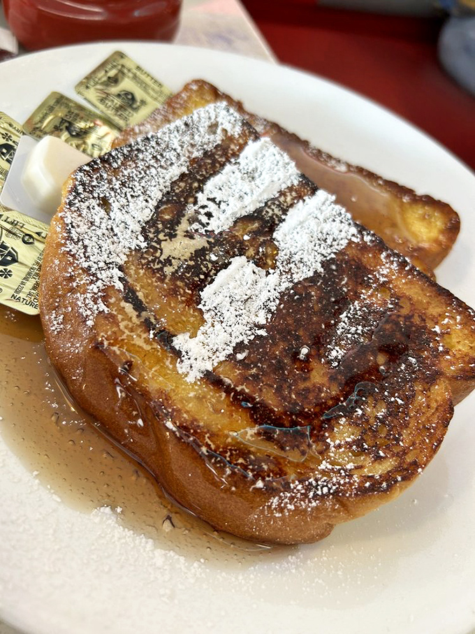 French toast dusted with powdered sugar like a Florida morning fog, sweet enough to make your dentist sense a disturbance in the force.