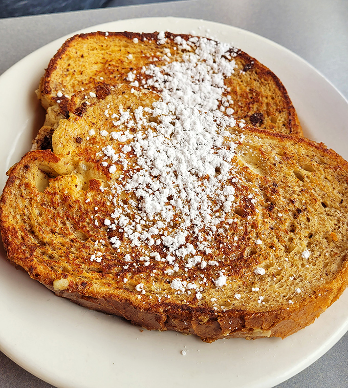 Golden French toast dusted with powdered sugar—breakfast that flirts with dessert in the most respectable morning relationship.