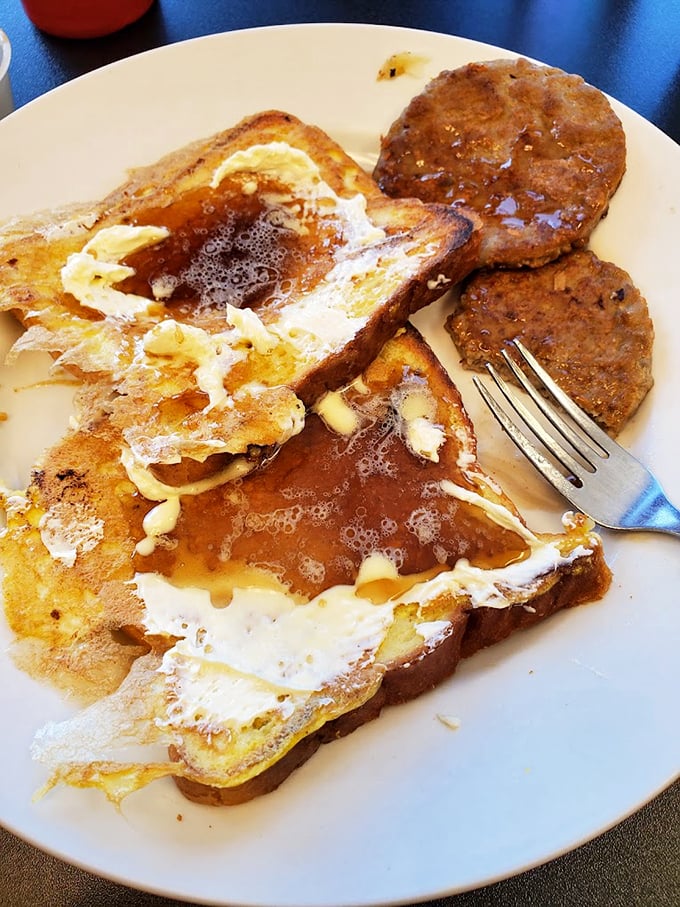 French toast that's achieved that mythical balance&mdash;crispy edges, custardy center, and enough maple syrup to make a Canadian blush. Those sausage patties aren't just sidekicks.
