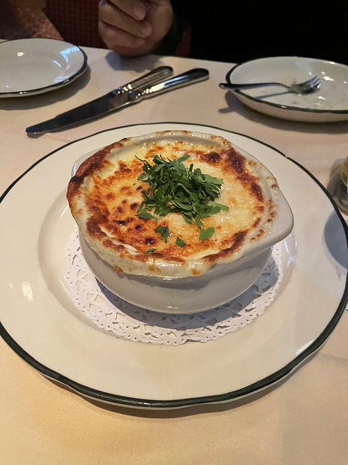 Behold the star of our show: French onion soup with a cheese canopy so perfect it makes you want to cancel your other dinner plans.