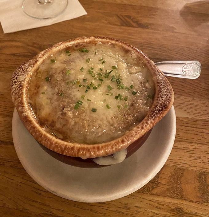 The French onion soup arrives like a bubbling cauldron of comfort, its golden cheese cap hiding a rich broth that could warm the coldest Pennsylvania evening.