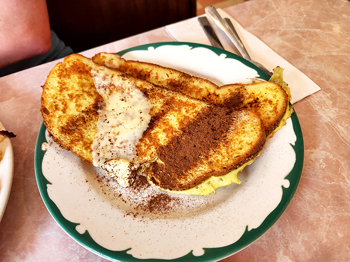 French toast that's achieved golden-brown perfection. That dusting of cinnamon isn't just for show&mdash;it's the exclamation point on a breakfast masterpiece.