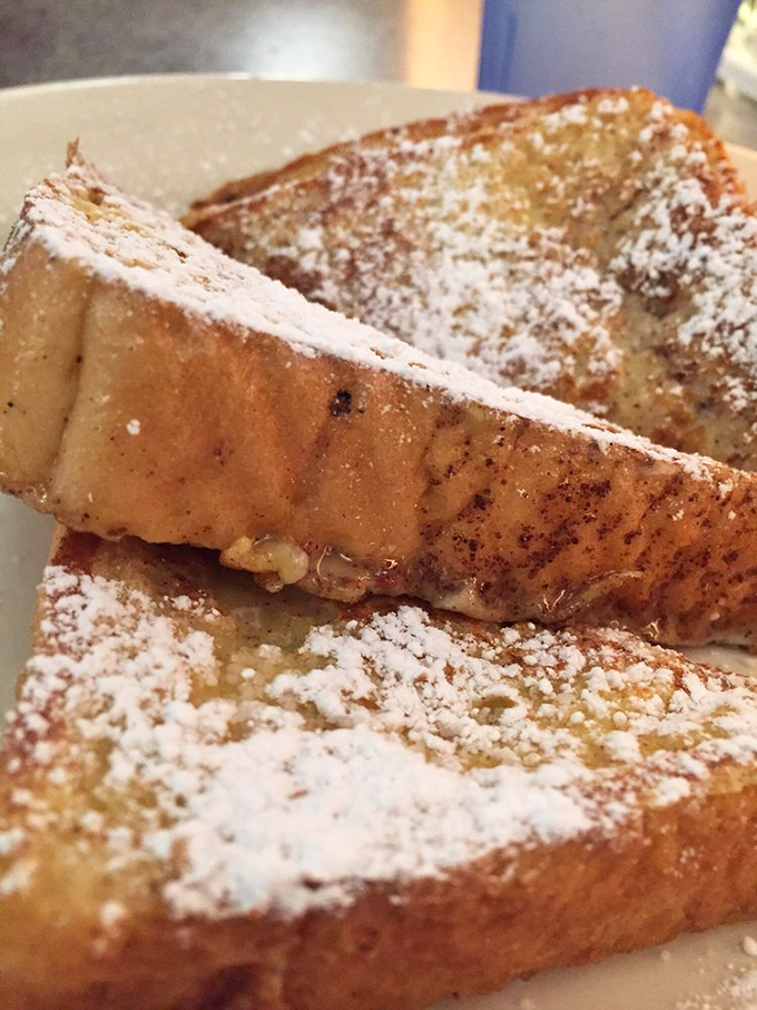 French toast that doesn't need a passport to impress. That dusting of powdered sugar is like fresh snow on comfort food mountain.