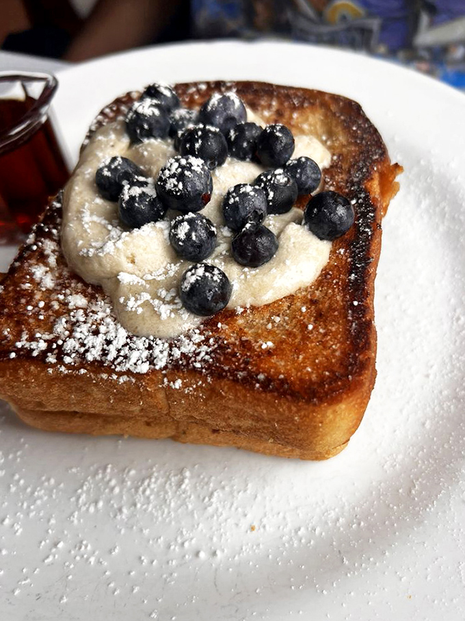 French toast that's dressed for success with blueberries, powdered sugar, and enough decadence to make breakfast feel like playing hooky.