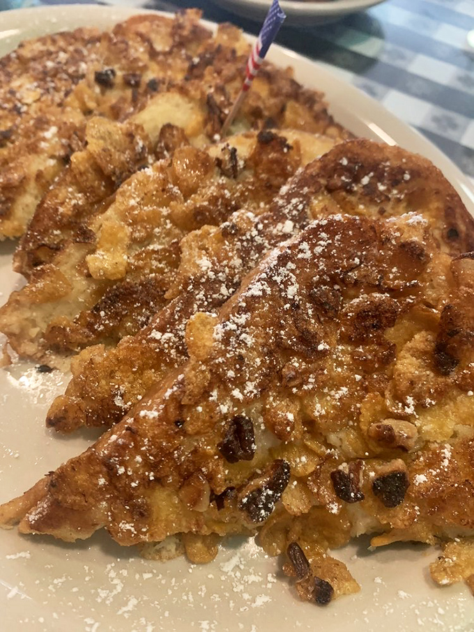 Crunchy French toast that's had a spa treatment in frosted flakes and nuts. Powdered sugar adds the finishing touch to this morning masterpiece.