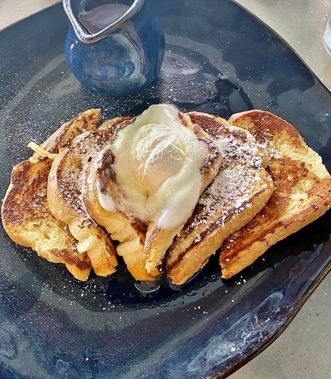 French toast that doesn't just say "good morning" but delivers a full breakfast soliloquy, complete with powdered sugar snow and melting ice cream.