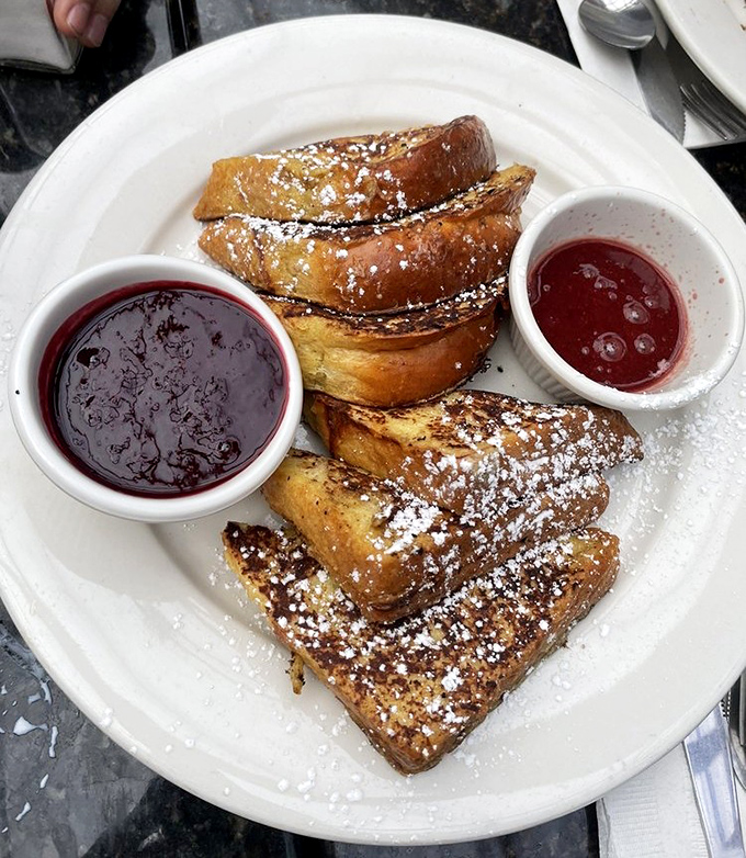 French toast that's dressed for success&mdash;powdered sugar snowfall, twin pools of berry compote, and a golden-brown exterior that shatters just right.
