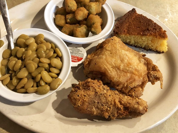 Fried chicken that crackles with each bite, alongside lima beans and cornbread. This isn't just a meal—it's a Southern heritage tour on a plate.