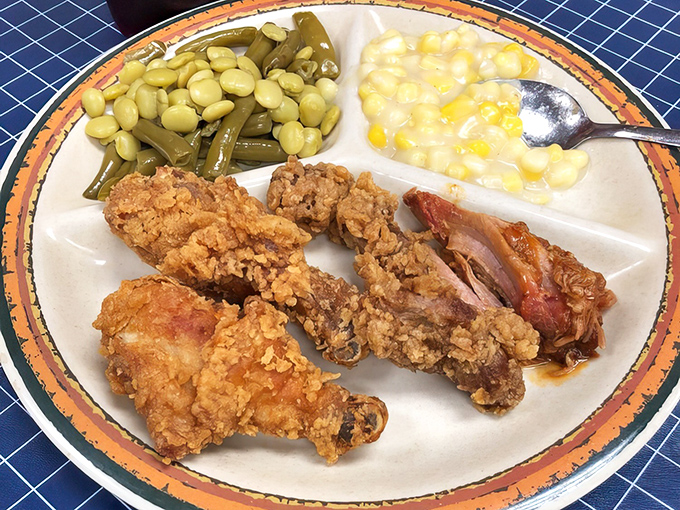 Fried chicken so perfectly golden it belongs in Fort Knox. Paired with butter beans and creamed corn, it's the South's greatest trilogy.