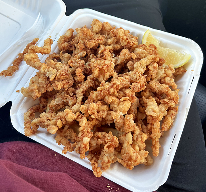 These aren't just fried clams&mdash;they're golden tickets to seafood nirvana, crispy on the outside, briny-sweet within. The lemon wedge isn't optional.