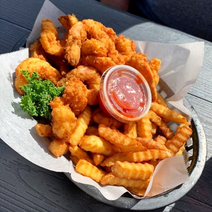 Golden fried colossal shrimp piled high with crispy fries &ndash; this is what happiness looks like on a plate.