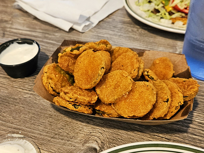 These golden-brown fried pickles aren't just a side dish&mdash;they're little discs of tangy, crunchy joy that disappear faster than you can say "more ranch, please."